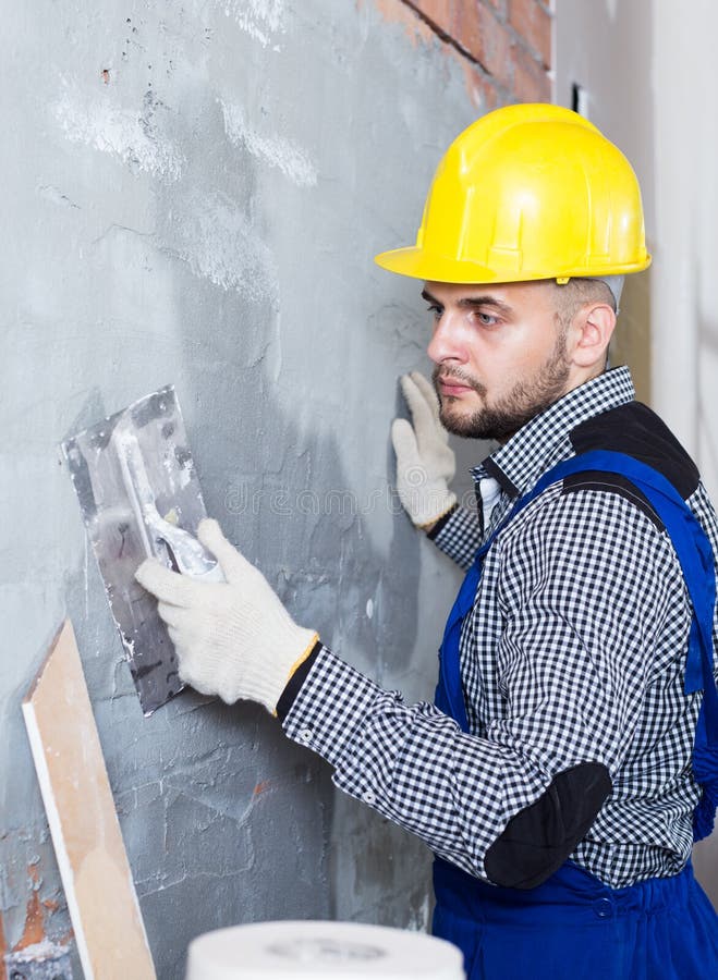 Man is plastering the wall stock image. Image of instrument - 200255751