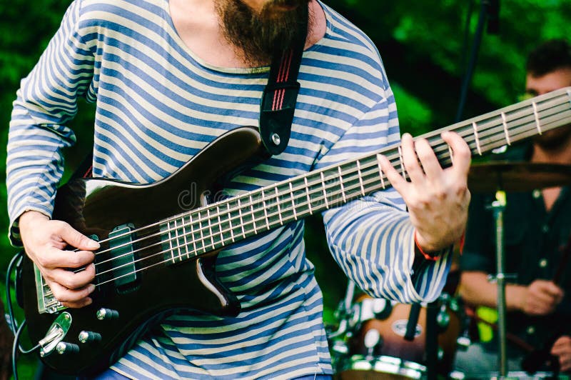 Man play on bass guitar stock photo. Image of closeup - 250665996