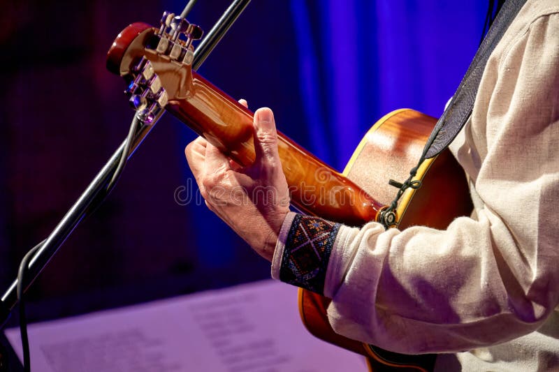 Man Playing an Acoustic Guitar in Front of a Microphone Stock Photo ...