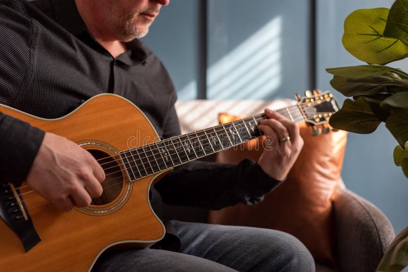 Man Playing Acoustic Guitar in Stylish Home Studio Stock Photo - Image ...