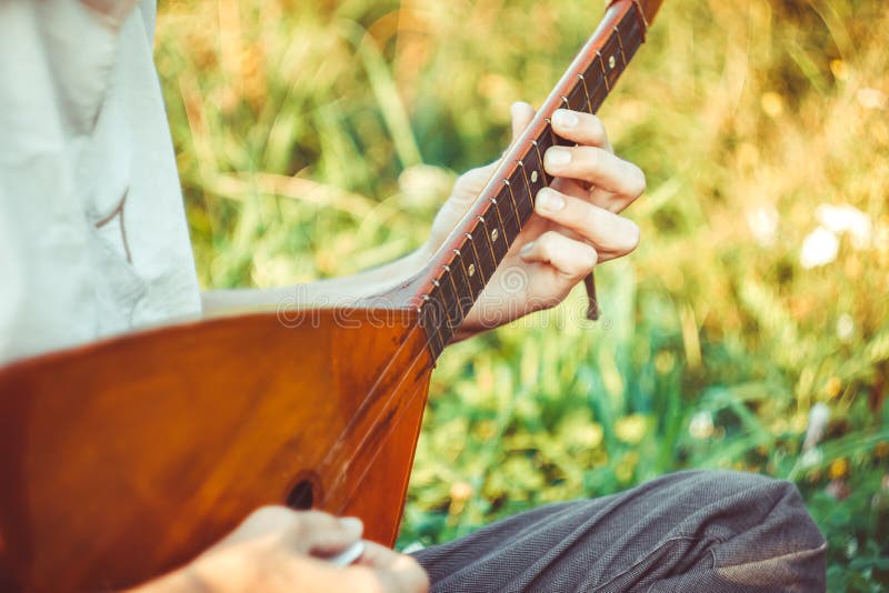 Man playing the balalaika stock image. Image of instrument - 146073119