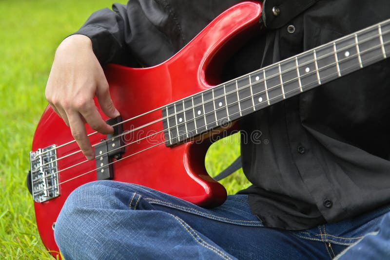 Man Playing the Bass Guitar Stock Photo - Image of outside, metal: 3845682