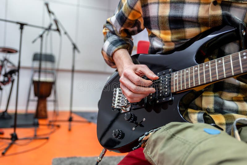 Man Playing Black Electric Guitar in Recording Studio Stock Image ...