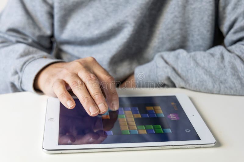 A Man Playing the Computer Game Tetris on a Tablet. Editorial Stock ...
