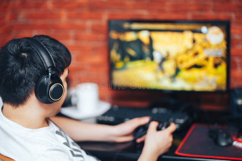 Man Playing a Computer Games in Headphones and Console Stock Image ...