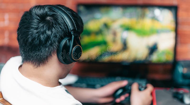 Man Playing a Computer Games in Headphones and Console Stock Photo ...