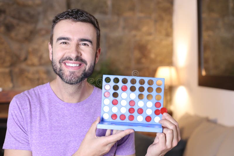 Man Playing Connect Four at Home Stock Photo - Image of activity, luck ...