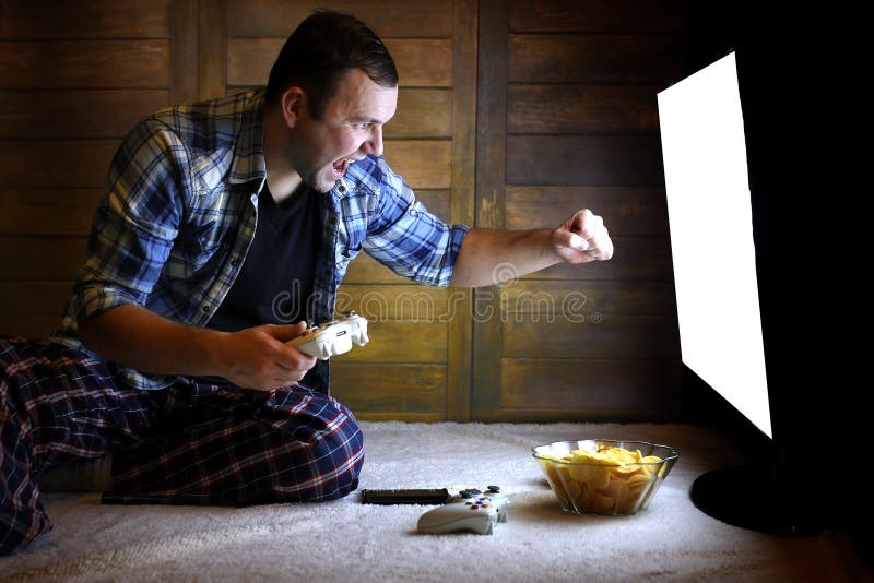 Man Playing on a Console on the Joystick before the Big TV Scree Stock ...