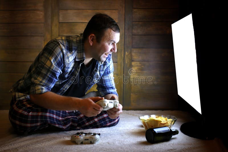 Man Playing on a Console on the Joystick before the Big TV Scree Stock ...