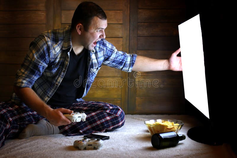 Man Playing on a Console on the Joystick before the Big TV Scree Stock ...