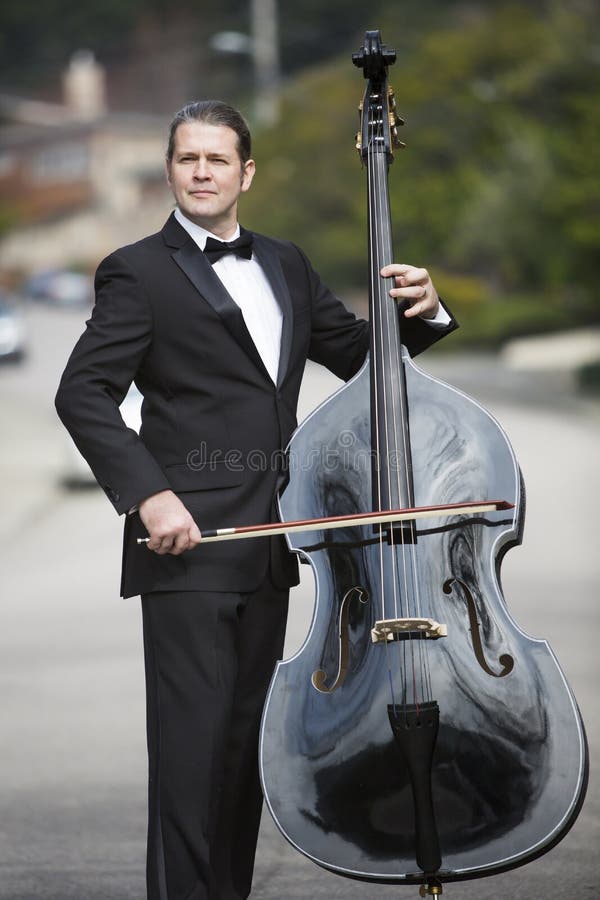 Man Playing the Double Bass in the Street Stock Photo - Image of formal ...