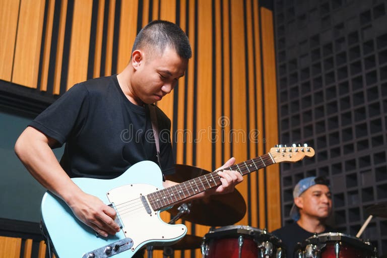 Man Playing Electric Guitar and Practicing with Friend in Home Studio ...