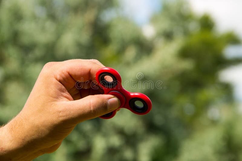 Man Playing with Fidget Spinner Stress Relieving Toy Outdoor Stock ...