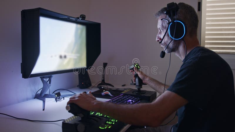 Man Playing a Flight Simulator on the Computer, Wearing a Headset Stock ...