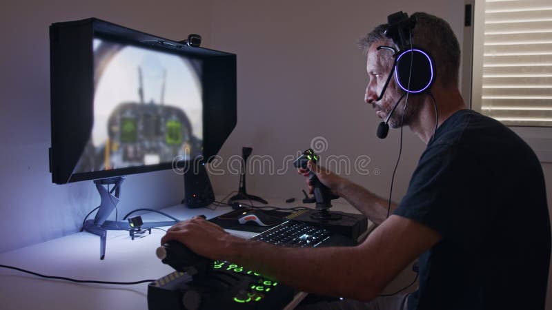 Man Playing a Flight Simulator on the Computer, Wearing a Headset Stock ...