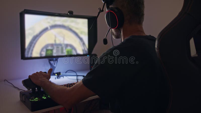 Man Playing a Flight Simulator on the Computer, Wearing a Headset Stock ...