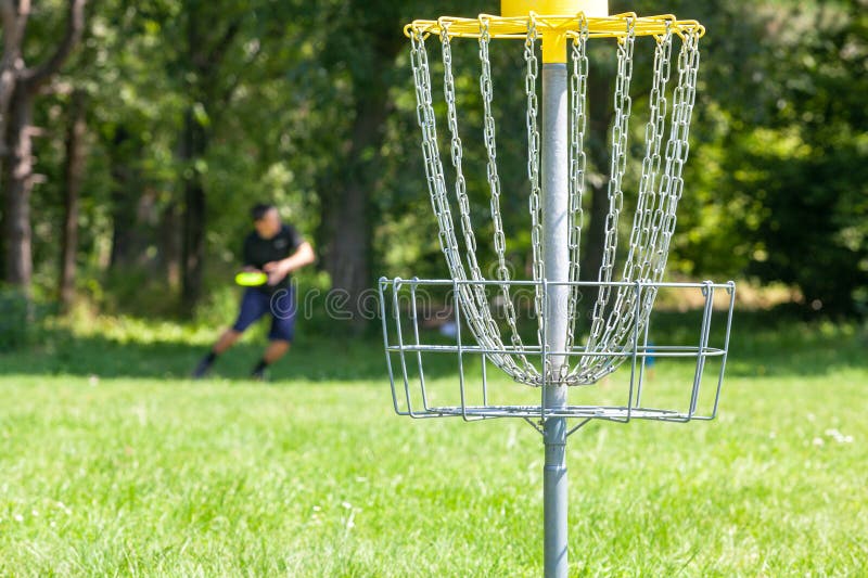 Man Playing Flying Disc Sport Game in the Park, Chain Basket in the ...