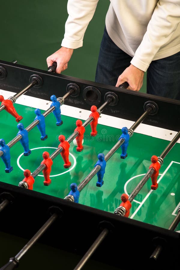 Man Playing Foosball Table Game Stock Photo - Image of attentive ...