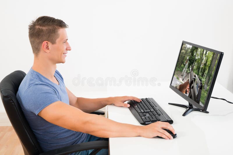 Man Playing Game On Desktop Computer Stock Photo - Image: 58558483