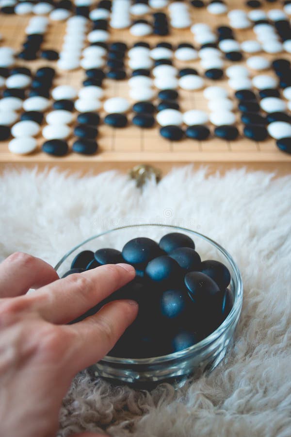 Man playing Go board game stock photo. Image of close - 68824462