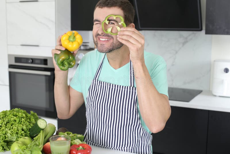 Man Playing with Green Bell Peppers in the Kitchen Stock Photo - Image ...