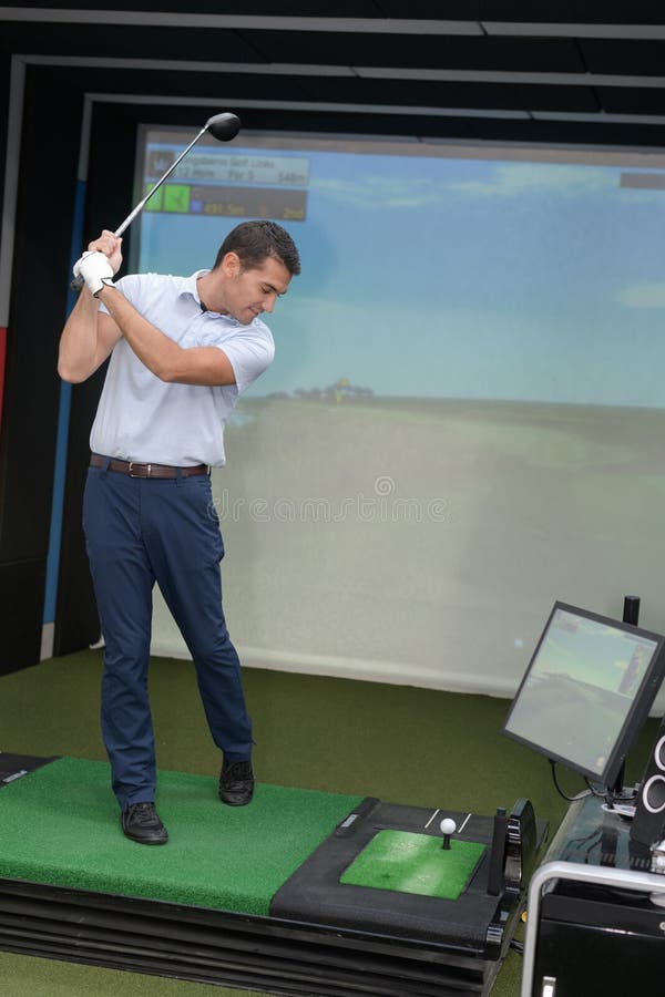 Man playing indoor golf stock photo. Image of workplace - 265339302