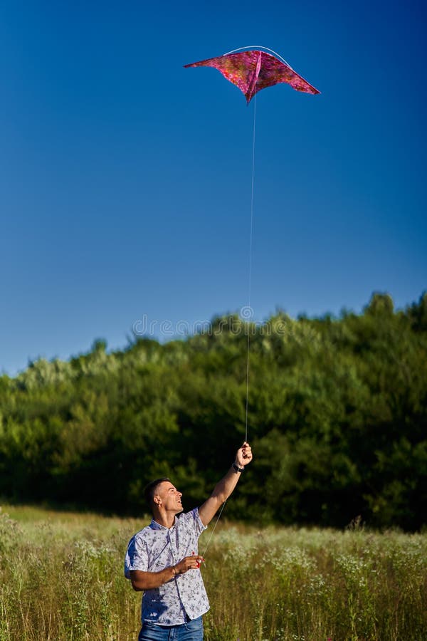 Man playing with a kite stock photo. Image of happiness - 224081804