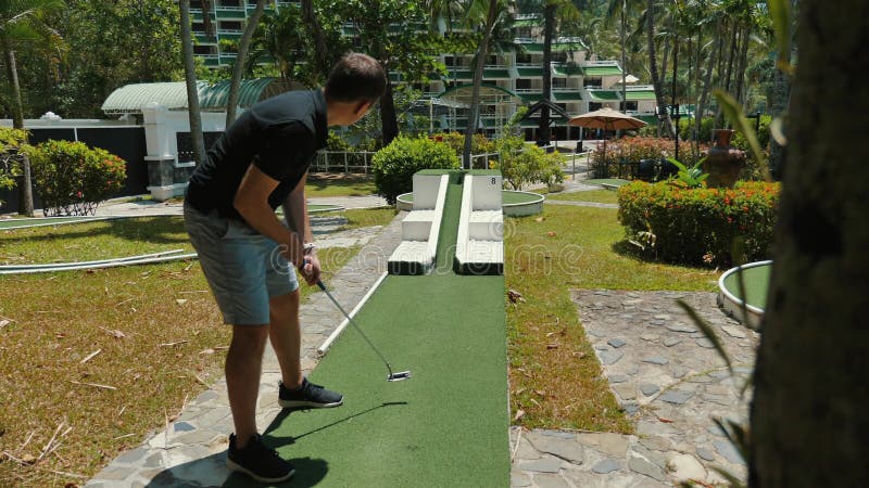 Man Playing Mini Golf at Tropical Stock Video - Video of iron, club ...