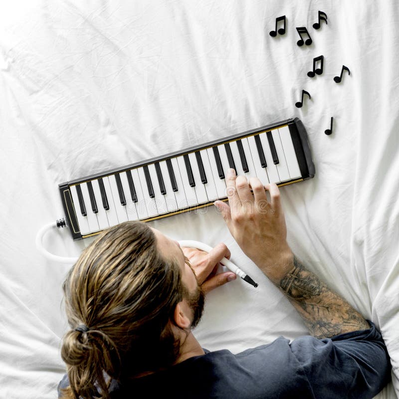 Man playing a mini piano stock photo. Image of musician - 109174136