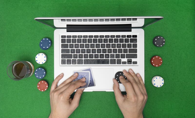 Man Playing Online Poker with Laptop on a Green Table with Chips Stock ...
