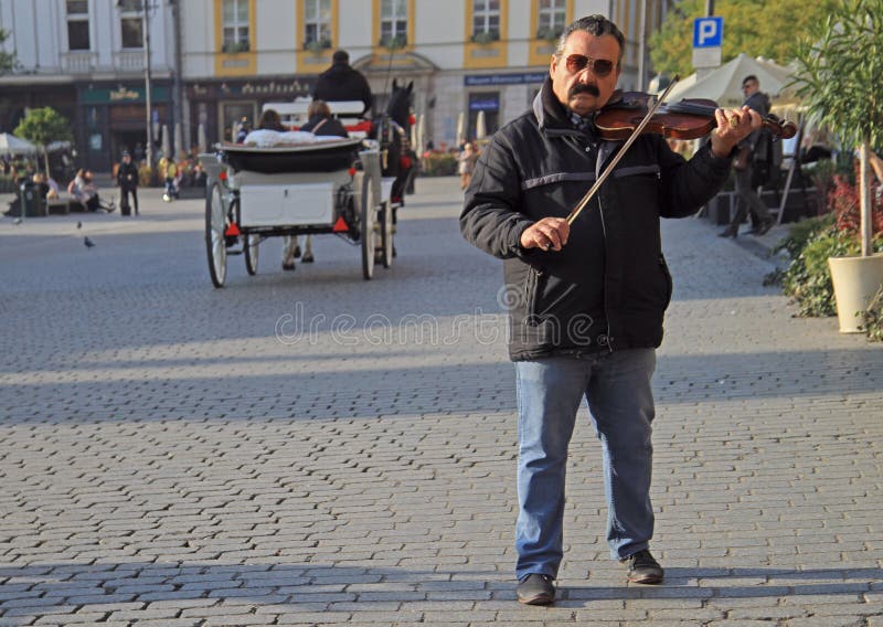 Man is Playing Outdoor at Main Square in Krakow, Poland Editorial ...