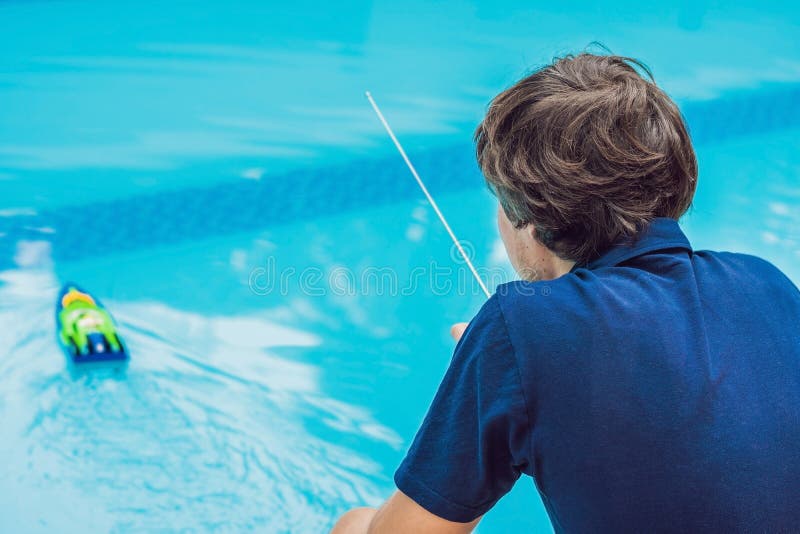 Man Playing with a Remote Controlled Boat in the Pool Stock Photo ...