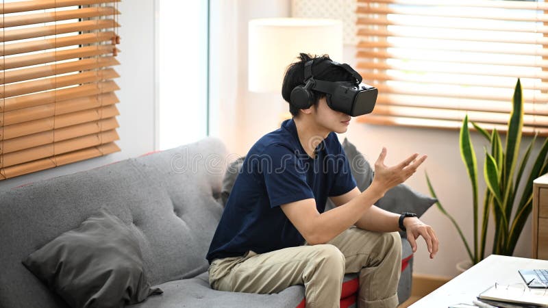 Man Playing Simulation Game with Virtual Reality Headset. Future ...