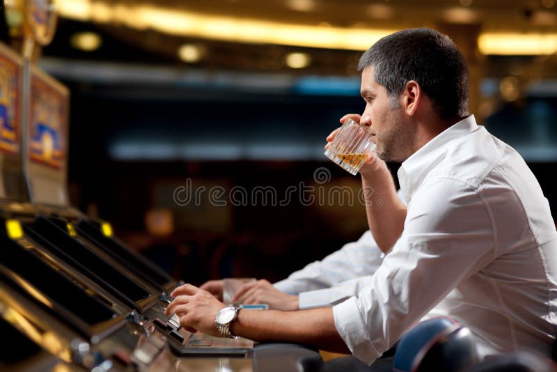 Man Playing the Slot Machine Stock Photo - Image of casino, horizontal ...