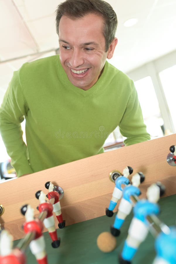 Man playing table football stock photo. Image of macro - 119530680
