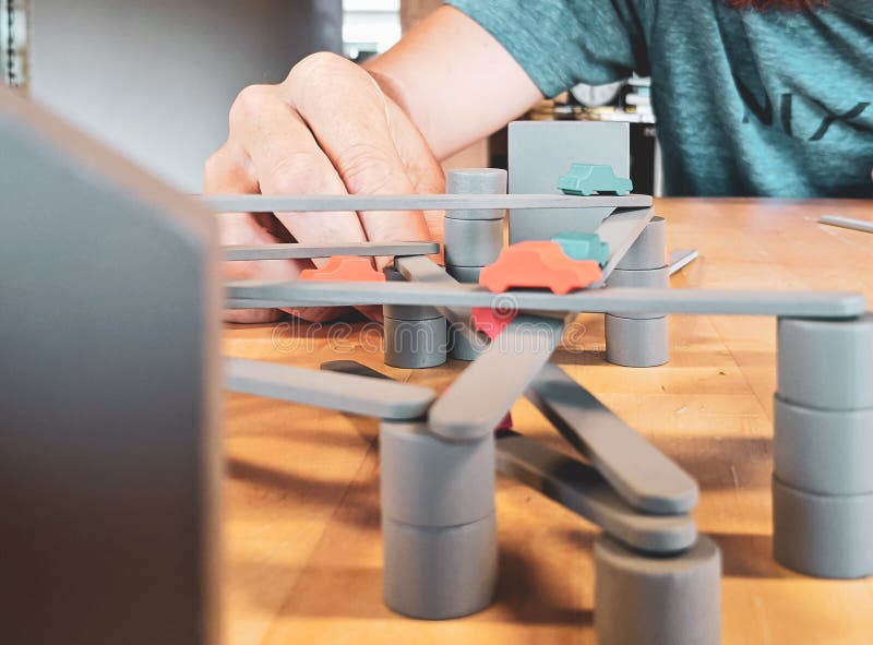 Man Playing a Technical Balancing Board Game on a Wooden Table Stock ...