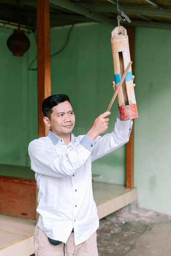 Man Playing Traditional Indonesian Bamboo Slit Drum Kentongan Outdoors ...