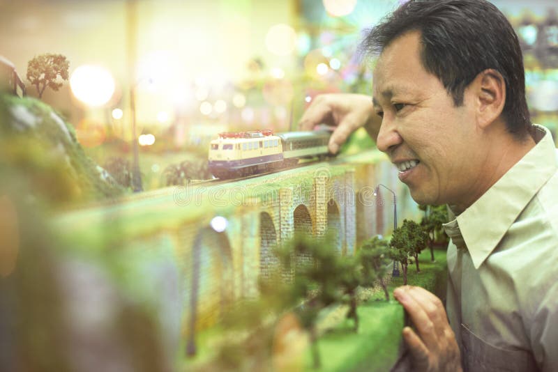 Man Playing with with a Train Set. Conceptual Image Stock Image - Image ...