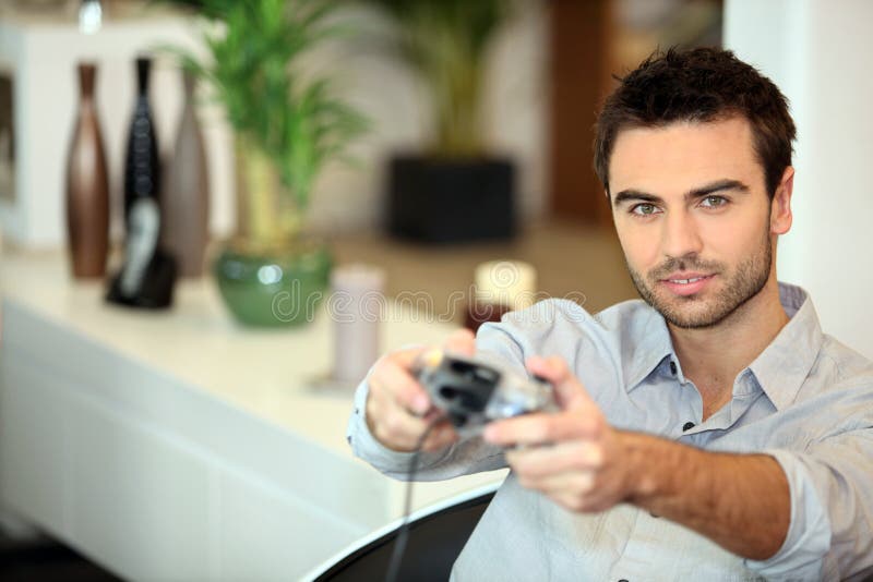 Man playing a video game stock photo. Image of absorbed - 21370386