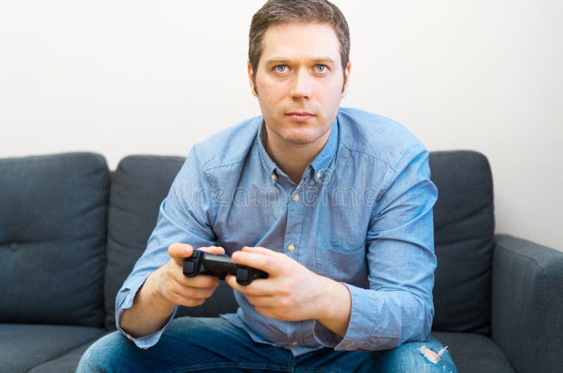Man playing video game. stock photo. Image of addiction - 144988722