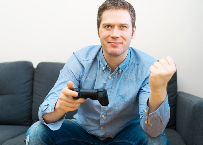 Man playing video game. stock image. Image of holding - 144988765