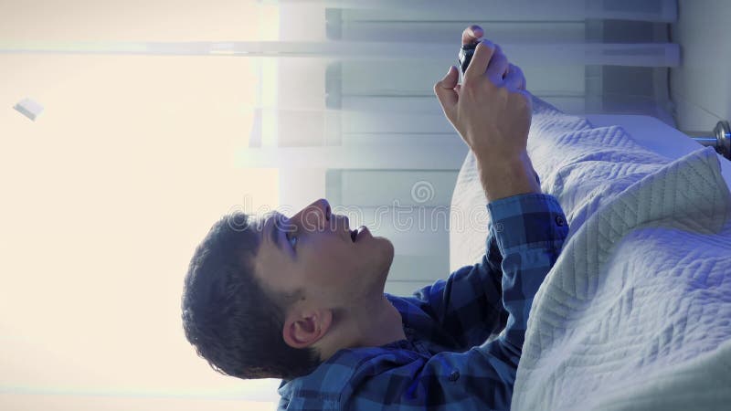 Man Playing Video Games and Using Wireless Joystick. Vertical Video ...