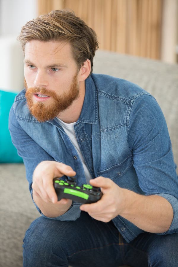 Man Playing Videogames on Sofa Stock Image - Image of blonde, handsome ...