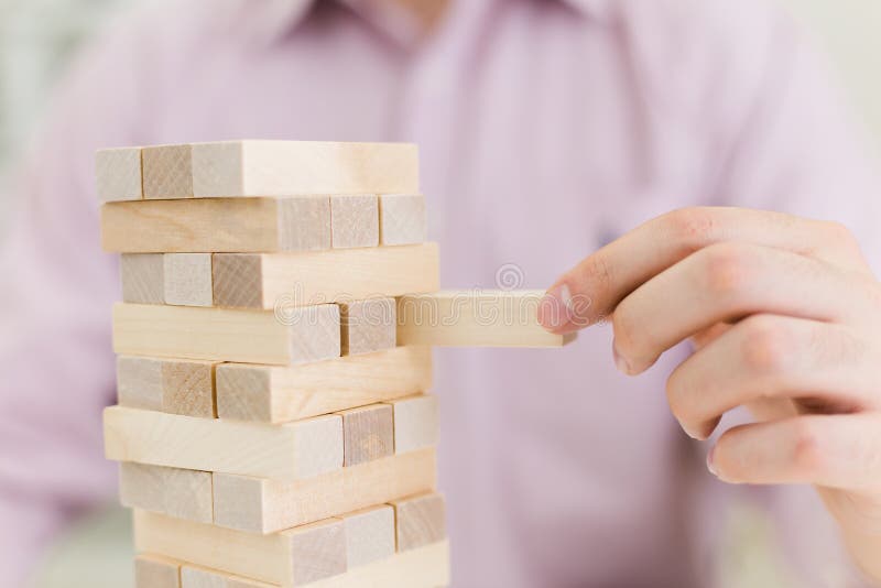 Man Playing with Wooden Blocks Stock Photo - Image of leader, close ...