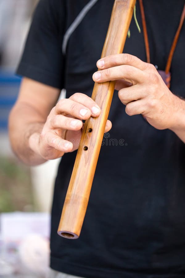 The Man is Playing on a Wooden Pipe Stock Photo - Image of wood ...