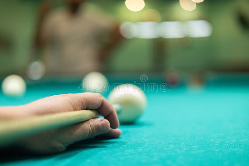A Man Plays Billiards Effectively and Hits the Ball with a Cue. a ...