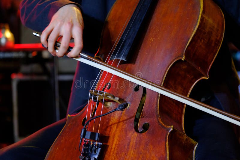 Man plays a cello on stage stock photo. Image of artist - 91805262