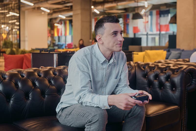 A Man Plays Games, Holds a Joystick in His Hands. a Console Game, a Guy ...