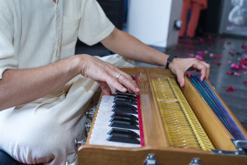 A Man Plays on a Musical Instrument. Emphasis on Hands Stock Image ...