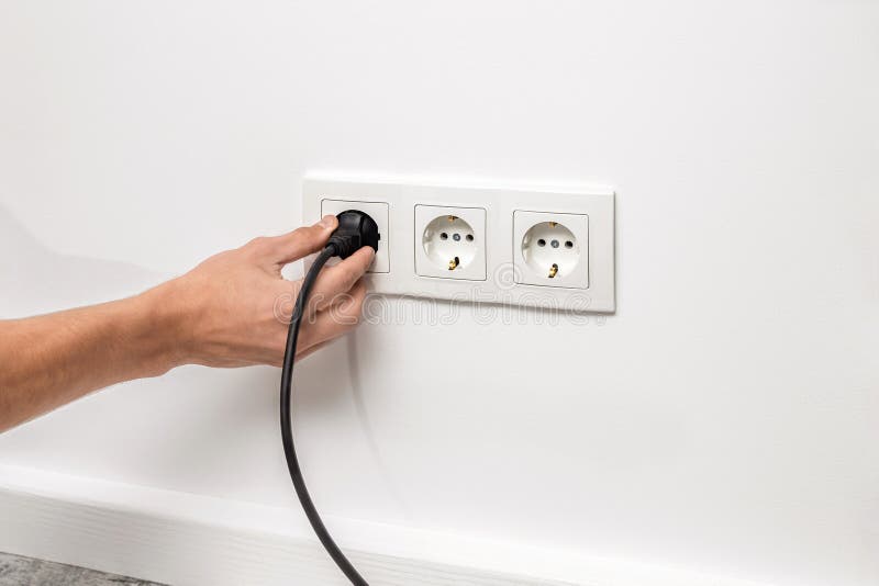 Man Plugging Cord into a Electrical Outlet Stock Image - Image of ...